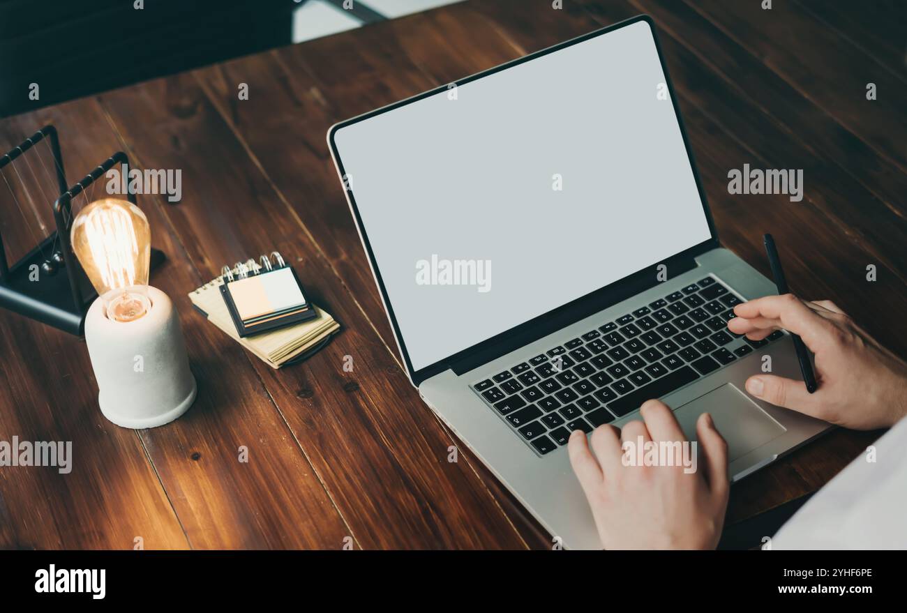 Male hands and laptop with blank screen. Mock-up of computer monitor ...