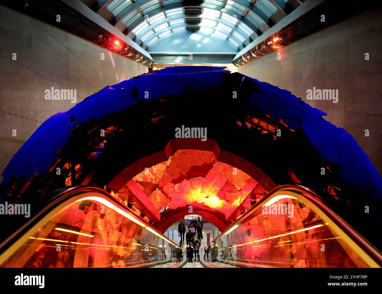 Visitors ascending an escalator to the Earth Gallery that passes ...
