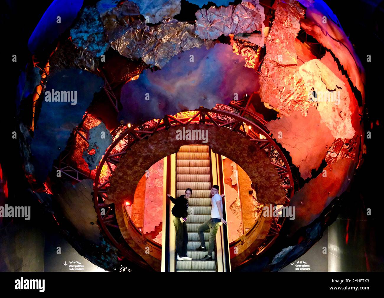 Visitors ascending an escalator to the Earth Gallery that passes ...