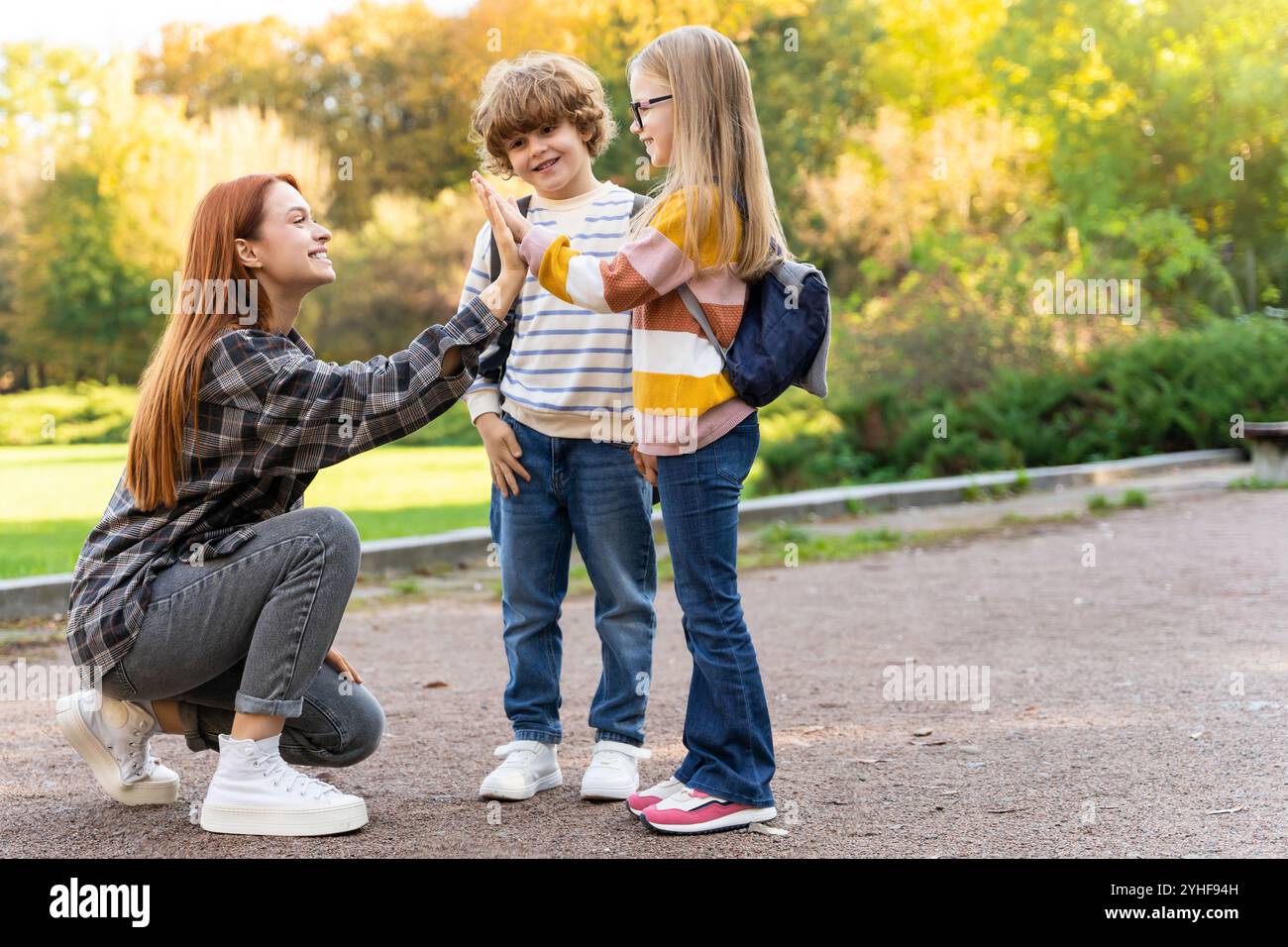 Children with their teacher in social gathering at park committed to ...