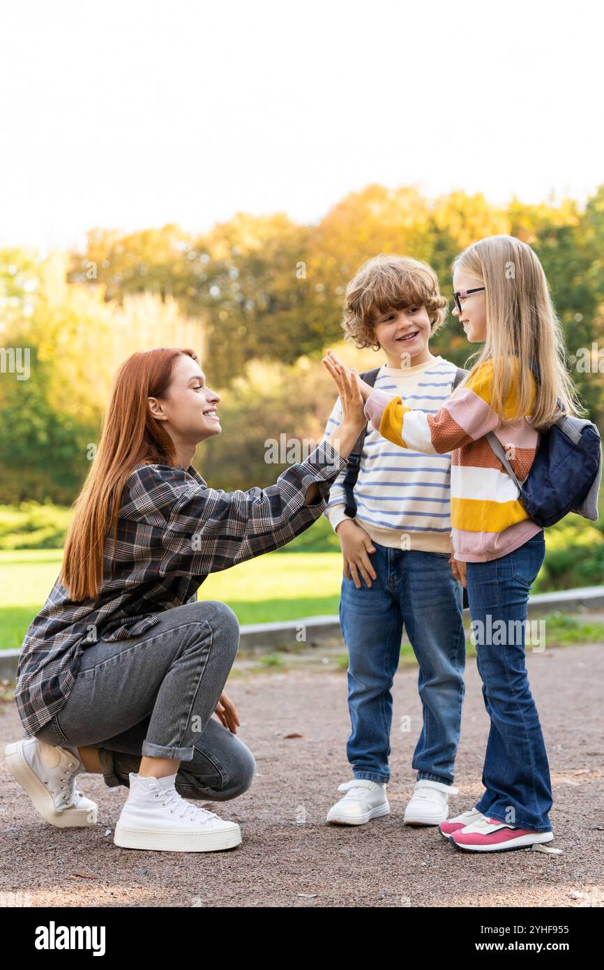 Children with their teacher in social gathering at park committed to ...