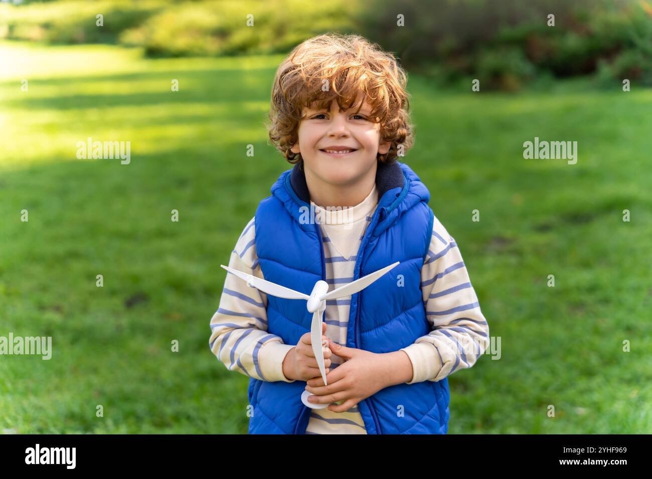 Kid boy exploring wind turbine model in protecting environment Stock ...