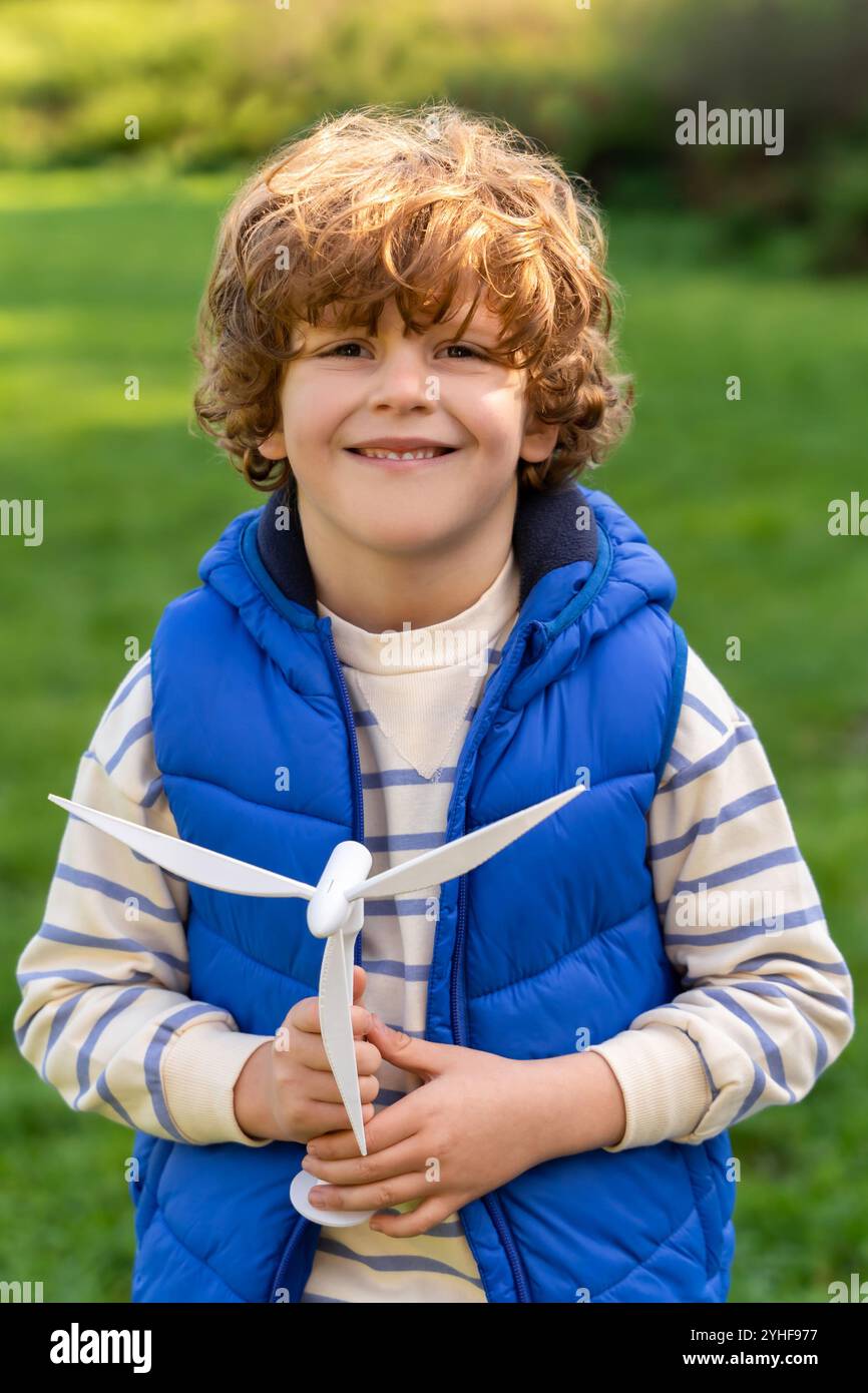 Kid boy exploring wind turbine model in protecting environment Stock ...