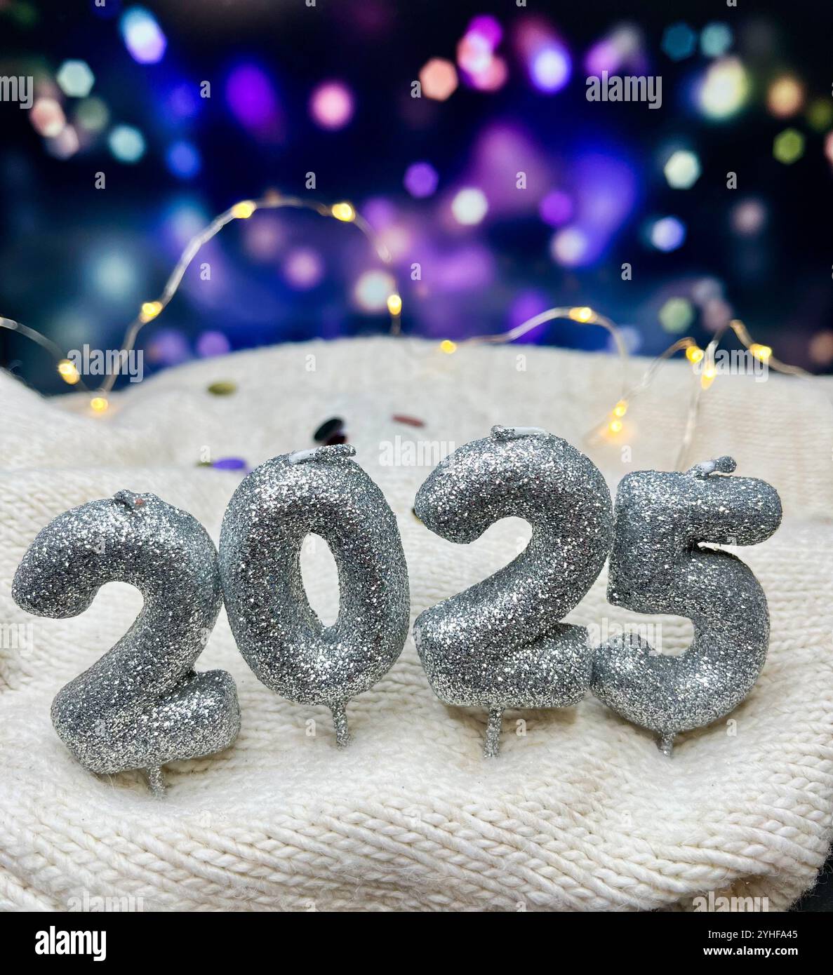Silver numerals reading 2025 are surrounded by festive decorations ...