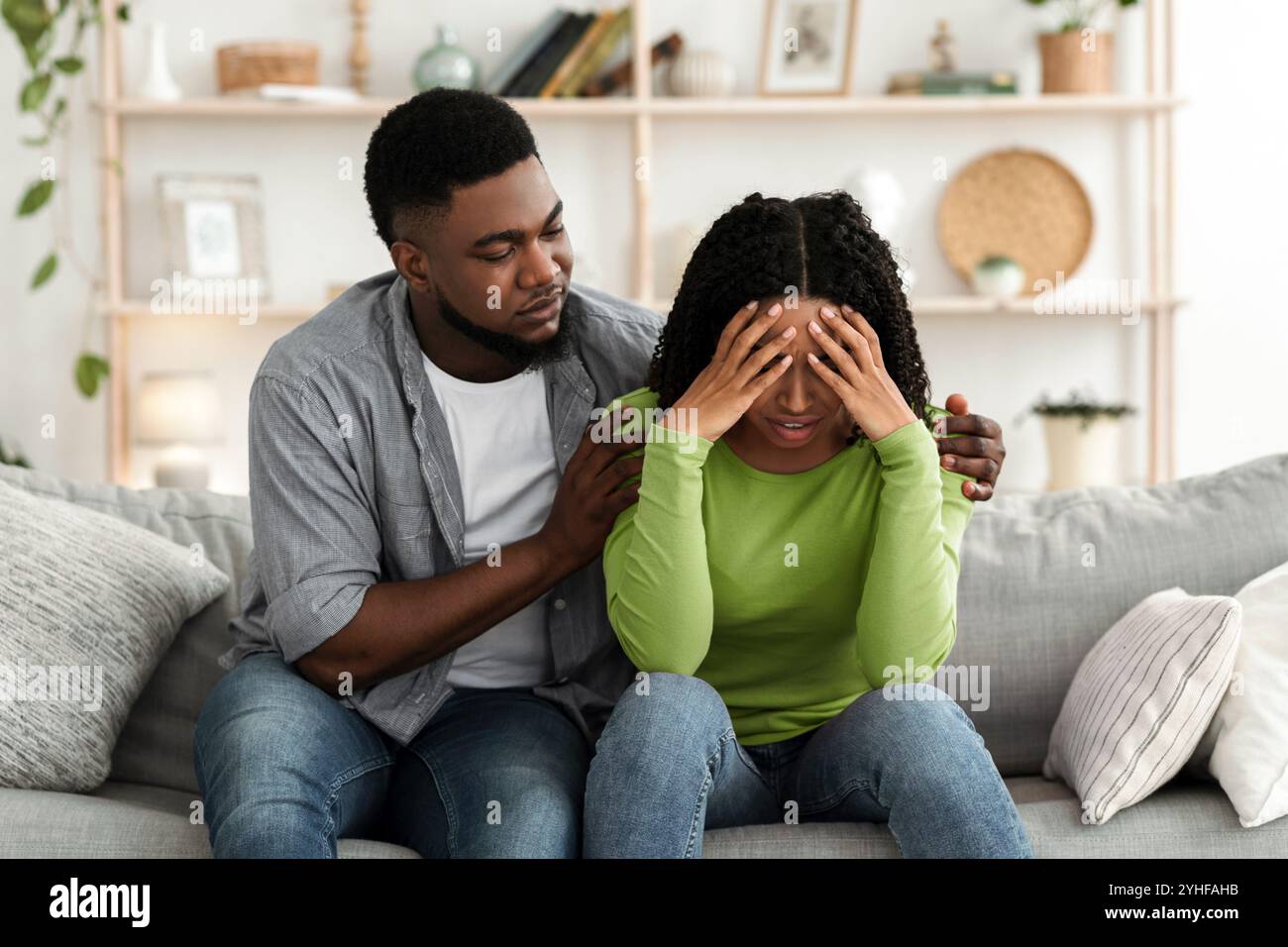 Caring husband comforting upset hi-res stock photography and images - Alamy