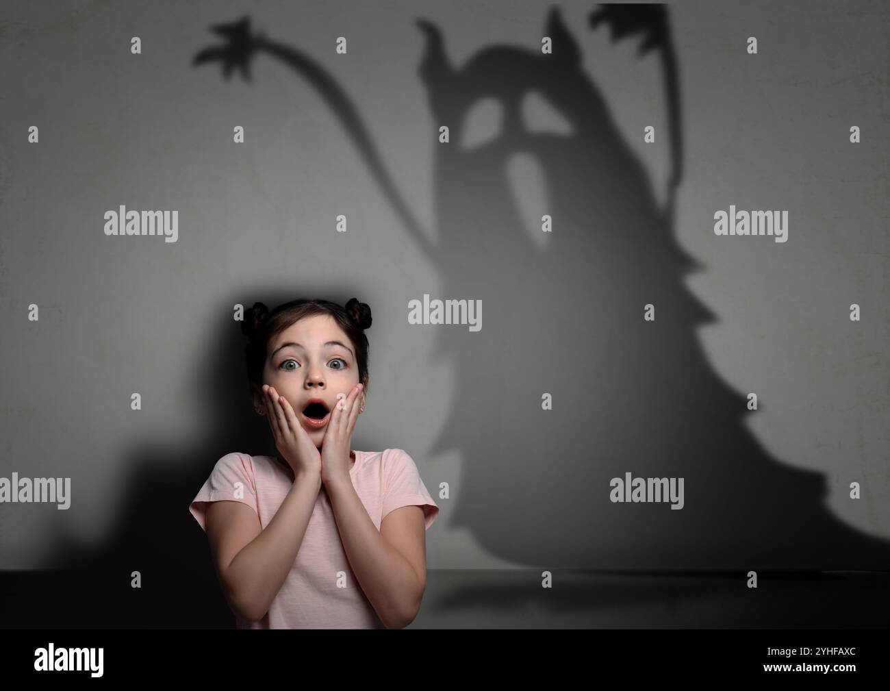 Little kid scared by monster. Spooky shadow on grey wall Stock Photo ...