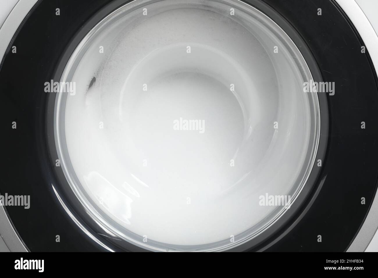 Washing machine with suds as background, closeup Stock Photo - Alamy