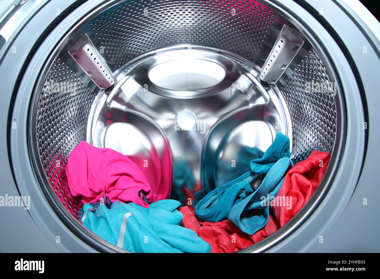 Washing machine with laundry as background, closeup Stock Photo - Alamy