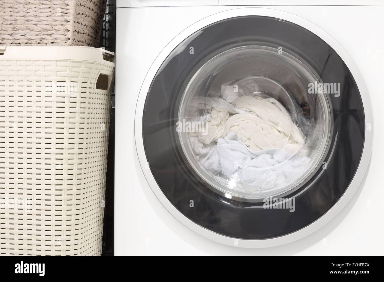 Washing machine with clothes as background, closeup Stock Photo - Alamy