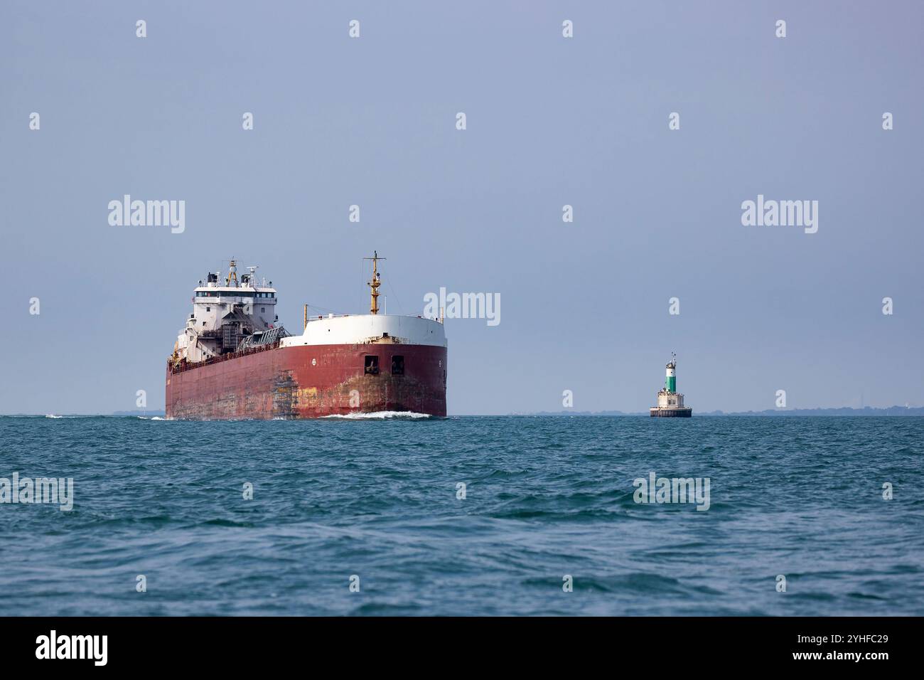 Great Lakes cargo ship passing a lighthouse Stock Photo - Alamy
