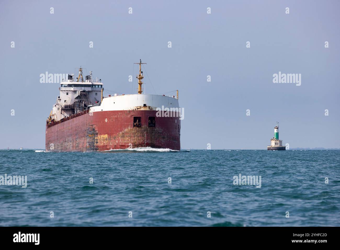 Great Lakes cargo freighter cruising past a lighthouse Stock Photo - Alamy