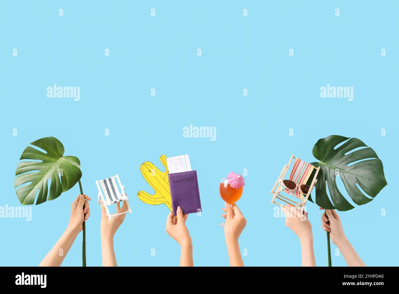 Female hands with mini deck chair, cocktail, passport, ticket, paper ...