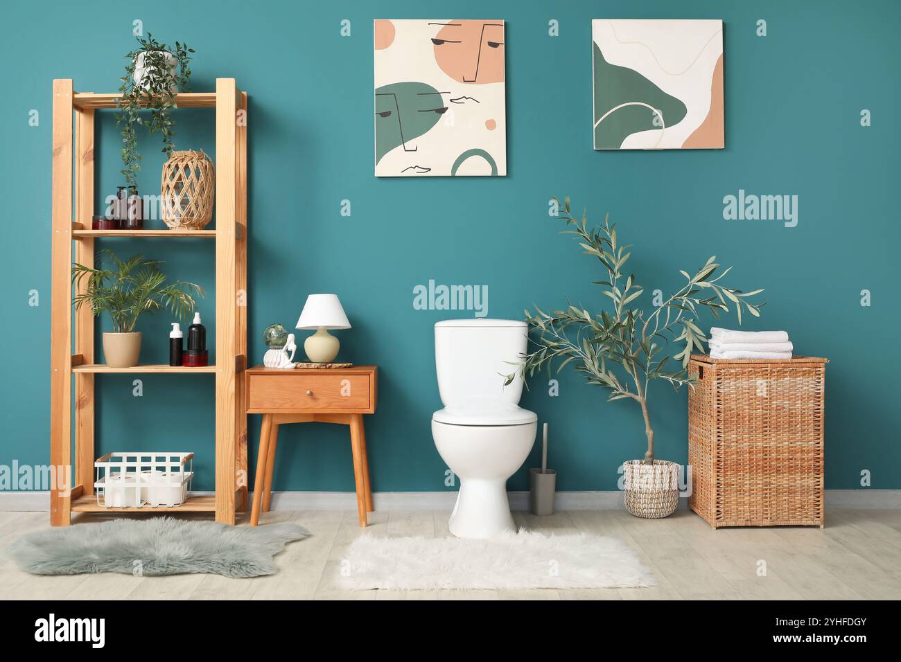 Interior of restroom with toilet bowl, table and shelf unit Stock Photo ...