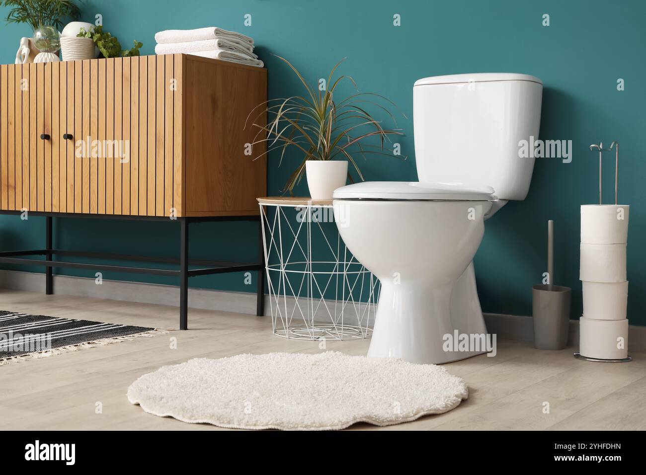 Interior of restroom with toilet bowl, commode and table Stock Photo ...