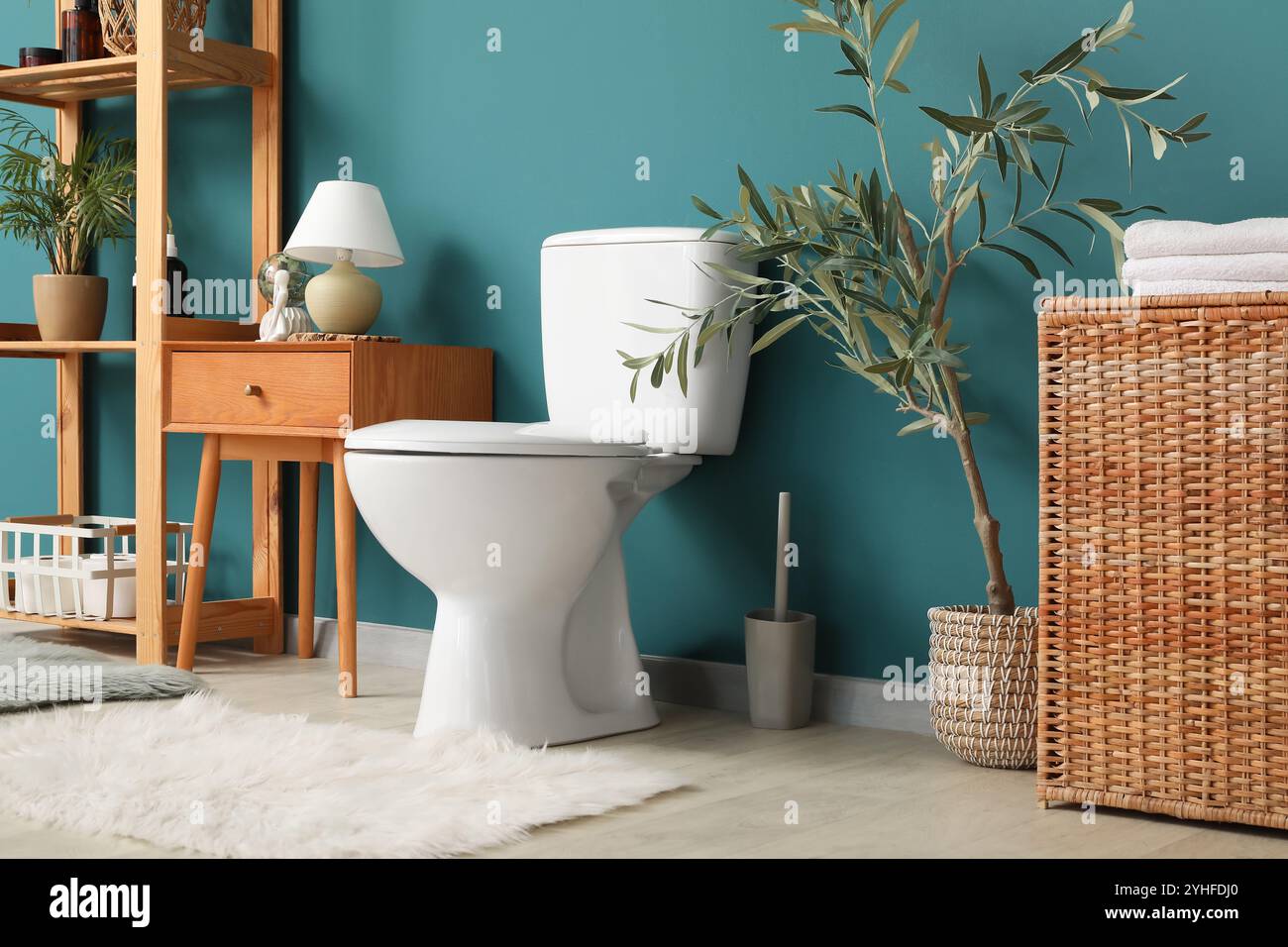 Interior of restroom with toilet bowl, table and shelf unit Stock Photo ...