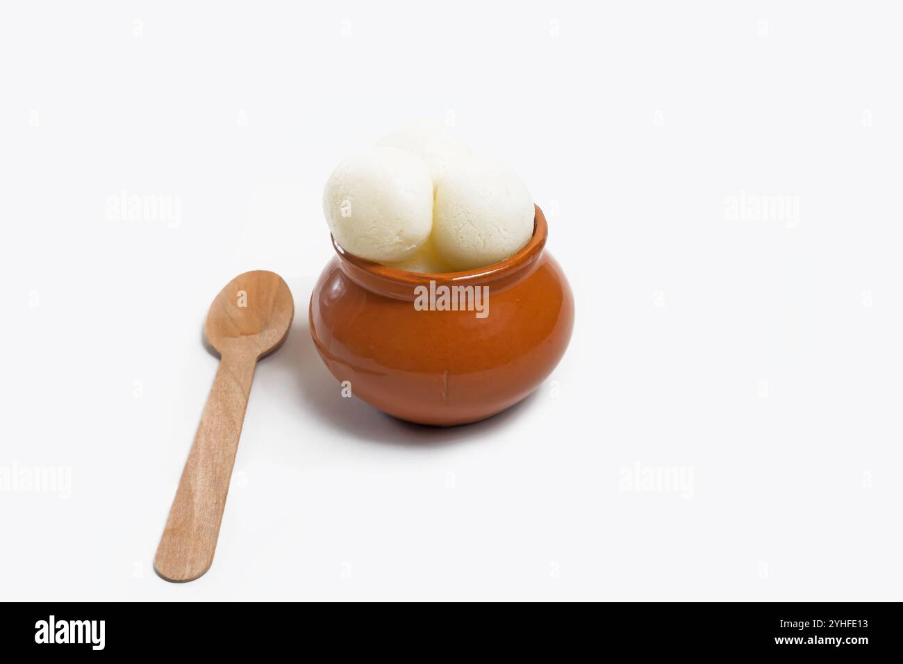 A traditional Indian dessert, Rasgulla, served in a rustic clay pot ...