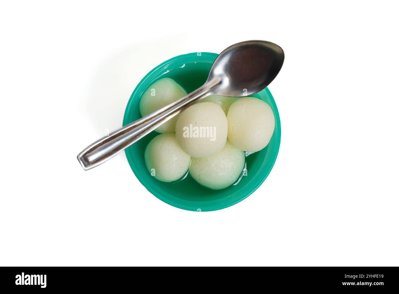 Traditional Indian rasgulla dessert in a green bowl with spoon on a ...
