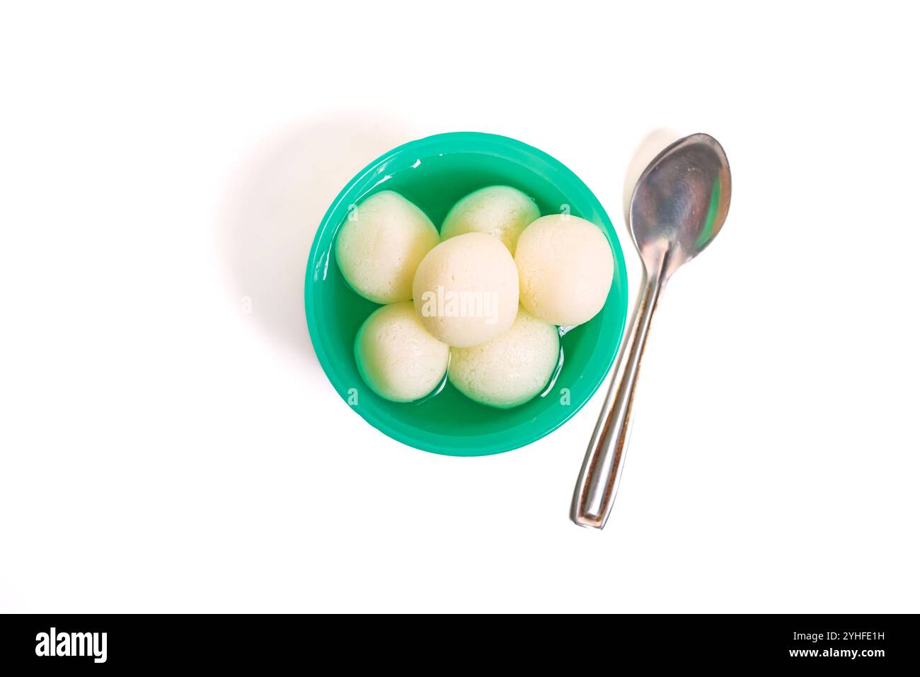 A top view of traditional Indian rasgulla served in a green plastic ...