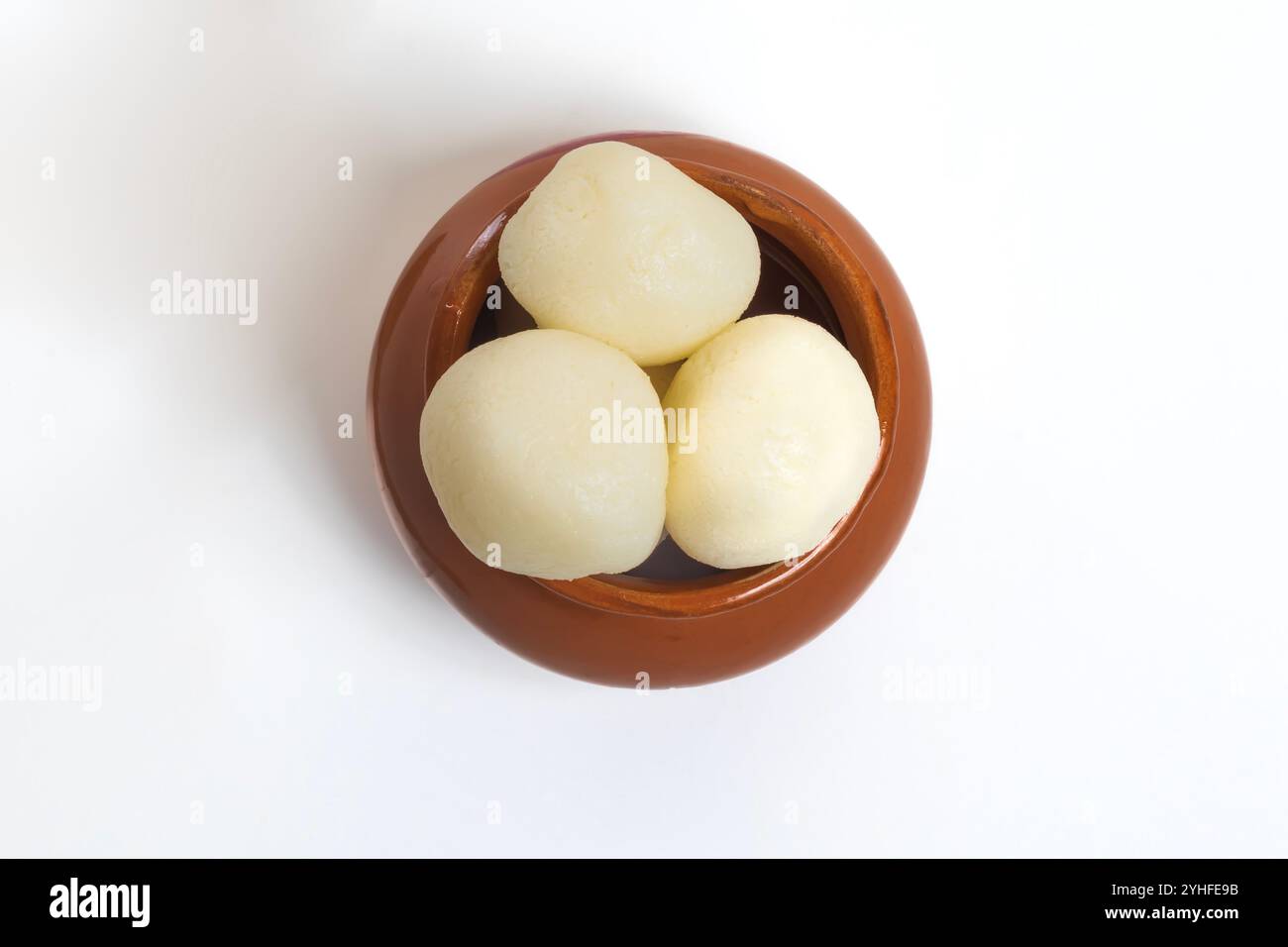Top view of Indian sweet rasgulla, placed in a clay pot, beautifully ...