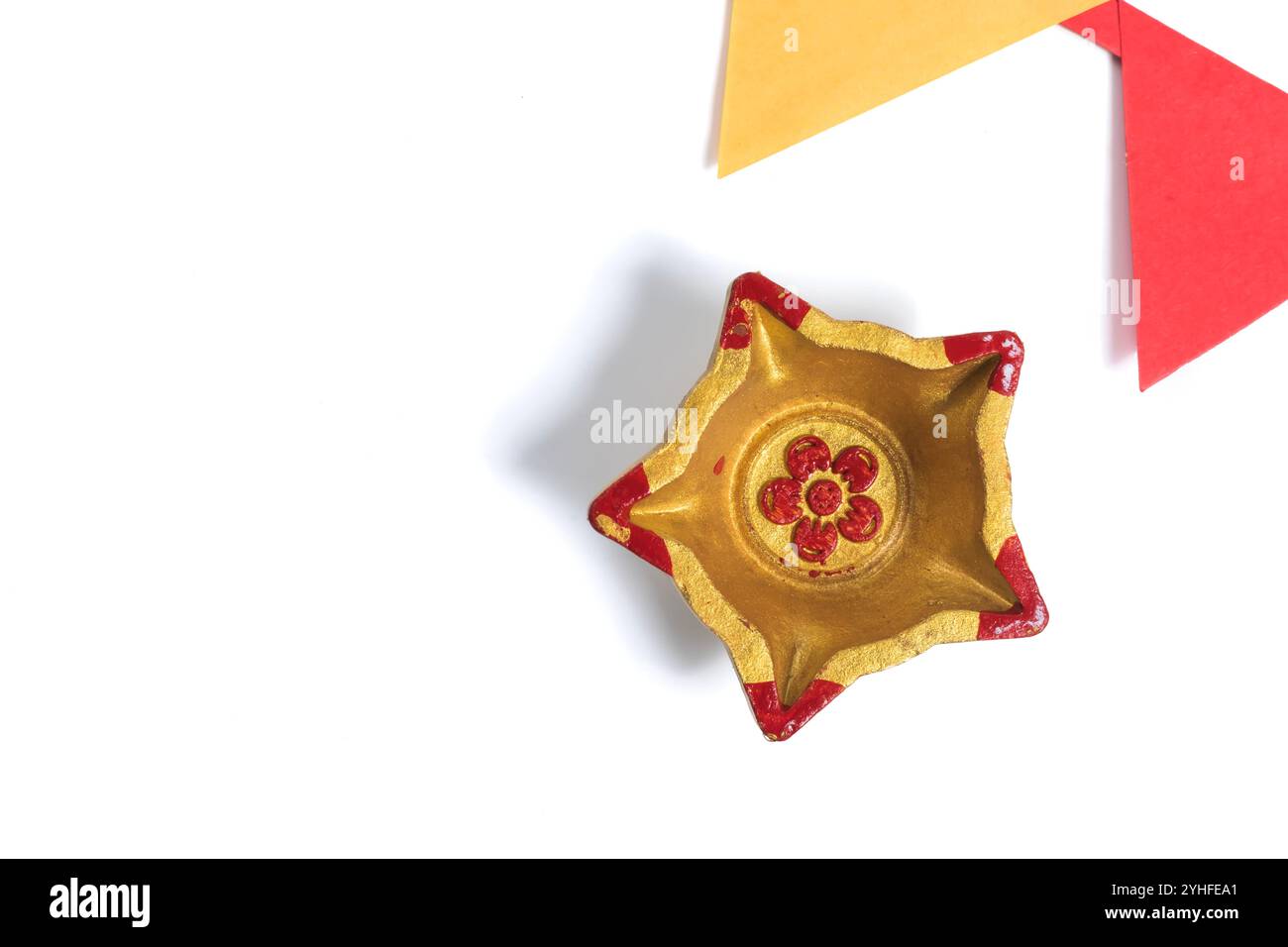 Top view of decorative colored paper flag with a golden star shape diya ...