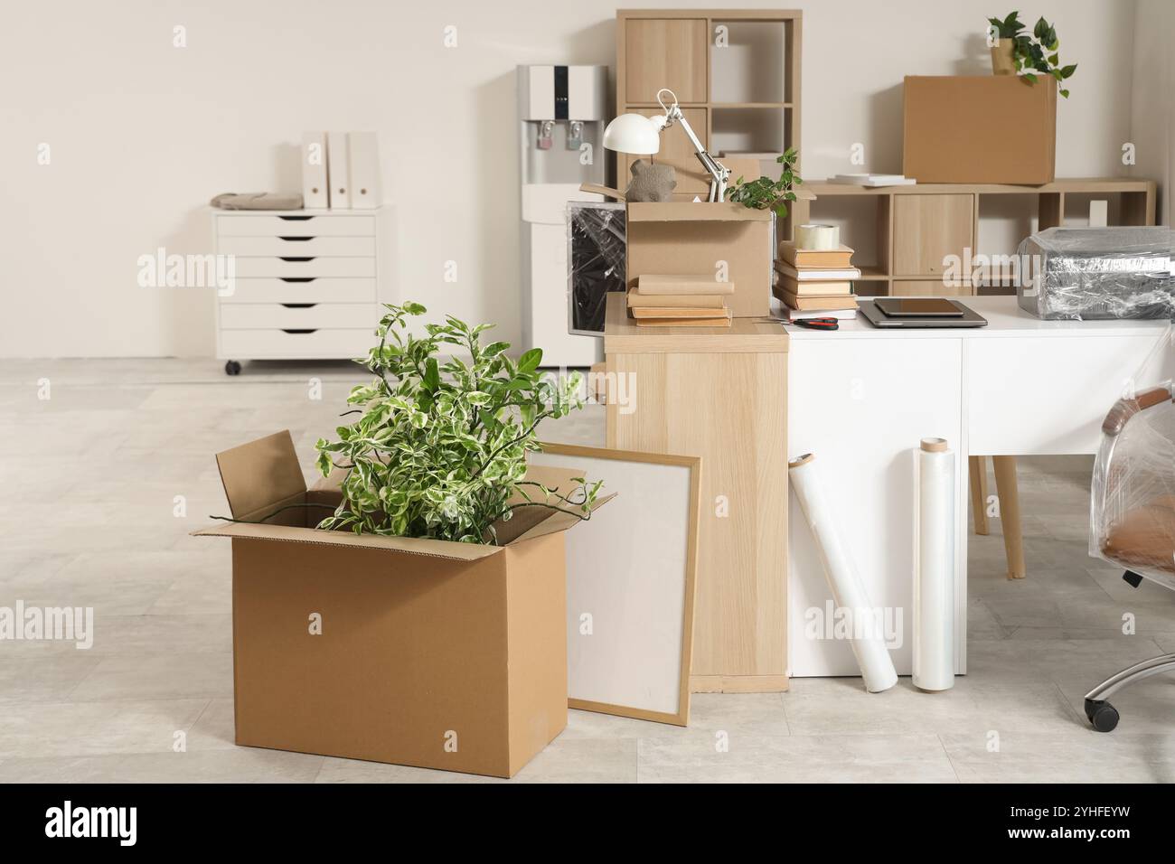 Desk with cardboard boxes in office on moving day Stock Photo - Alamy