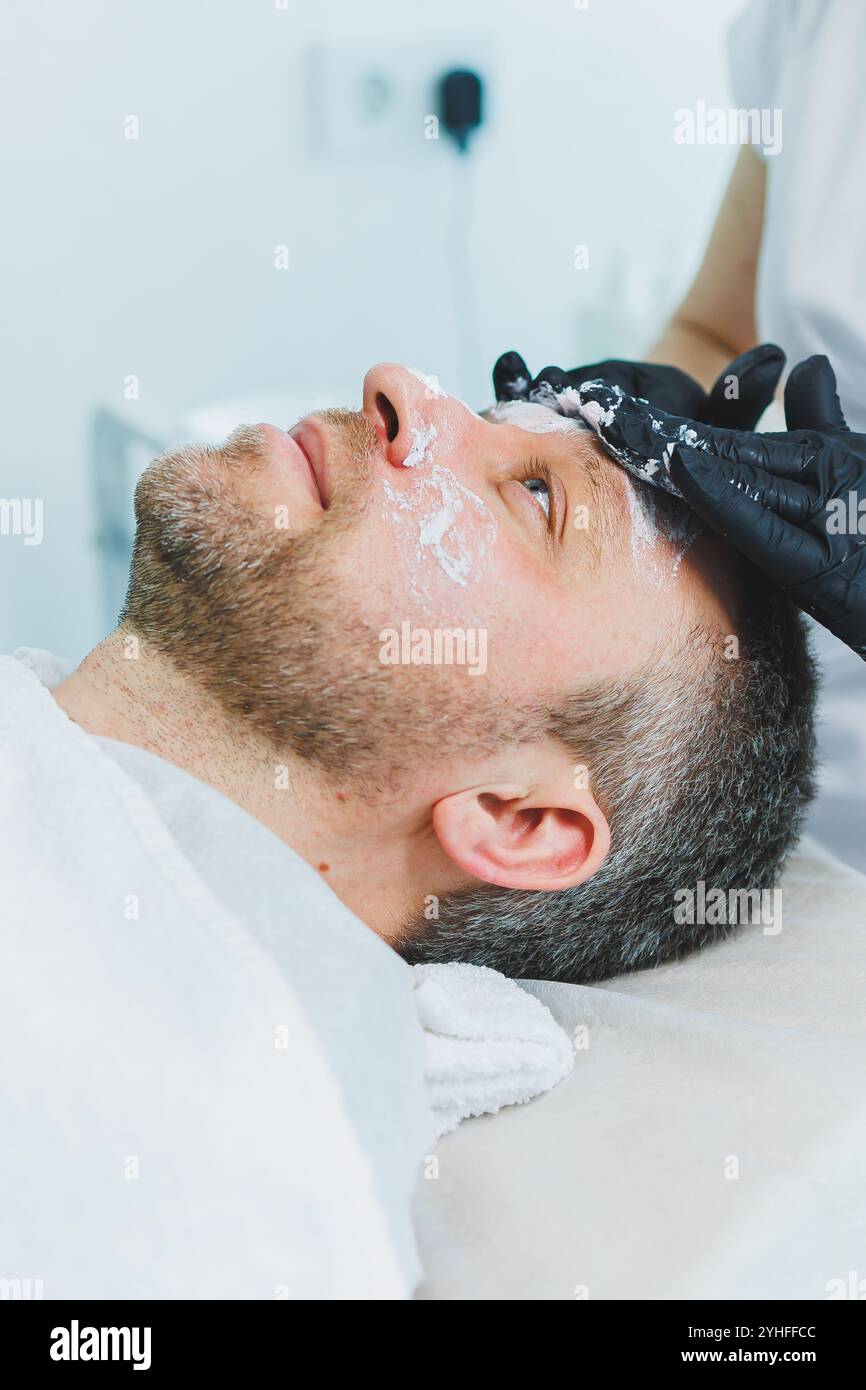 A man with a mask in a beauty salon. Men's face care concept. A ...