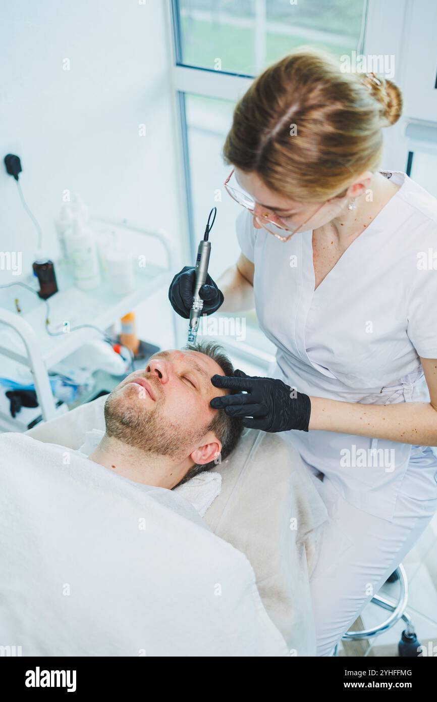 Male cosmetology in a beauty salon. A man takes care of his facial skin ...