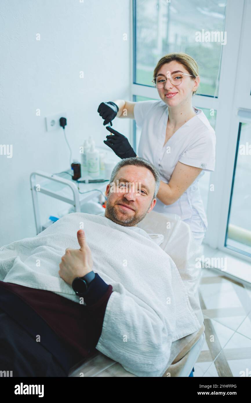 Male cosmetology in a beauty salon. A man takes care of his facial skin ...
