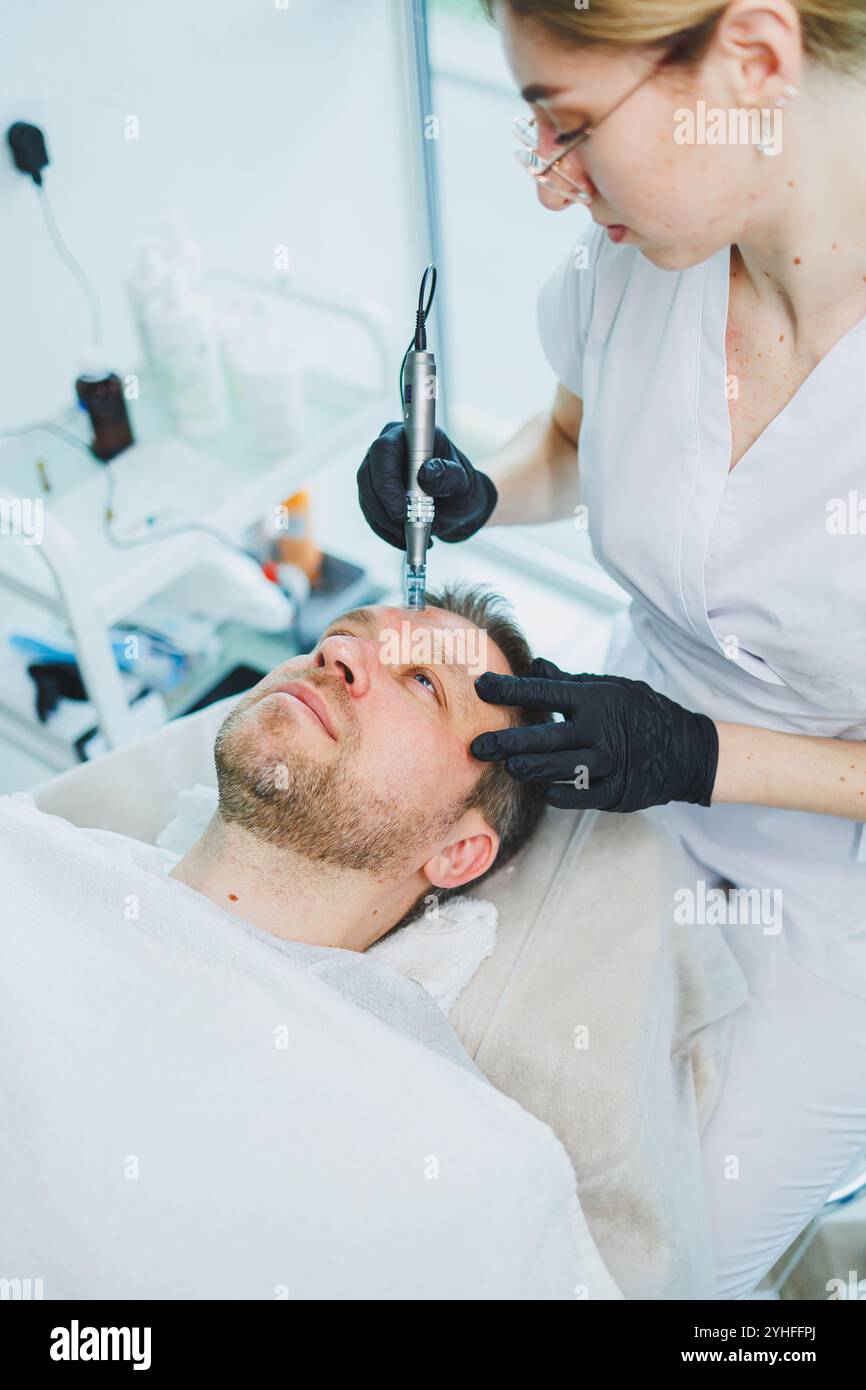Male cosmetology in a beauty salon. A man takes care of his facial skin ...