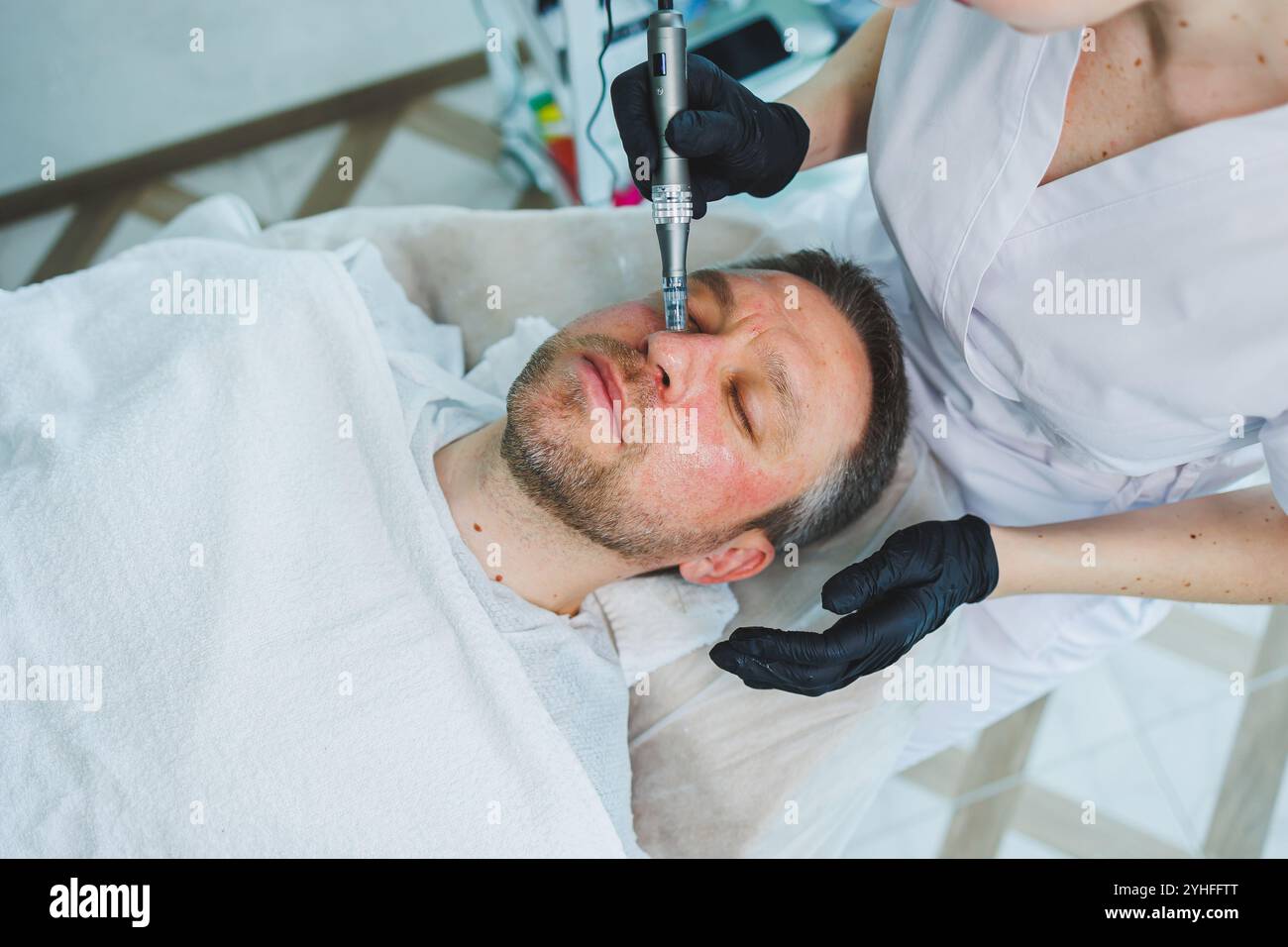 Male cosmetology in a beauty salon. A man takes care of his facial skin ...