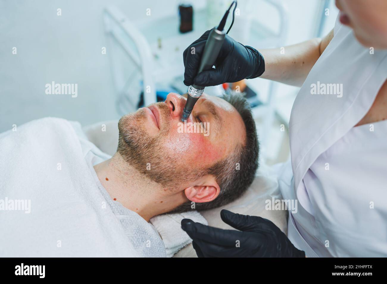 Male cosmetology in a beauty salon. A man takes care of his facial skin ...