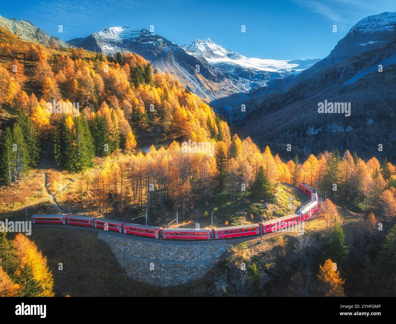 Bernina express train is moving along the swiss alps in autumn Stock ...
