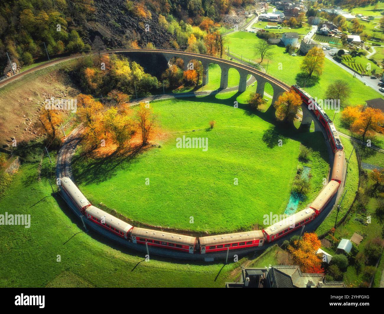 Aerial view of red train on Kreisviadukt Brusio in mountains Stock ...