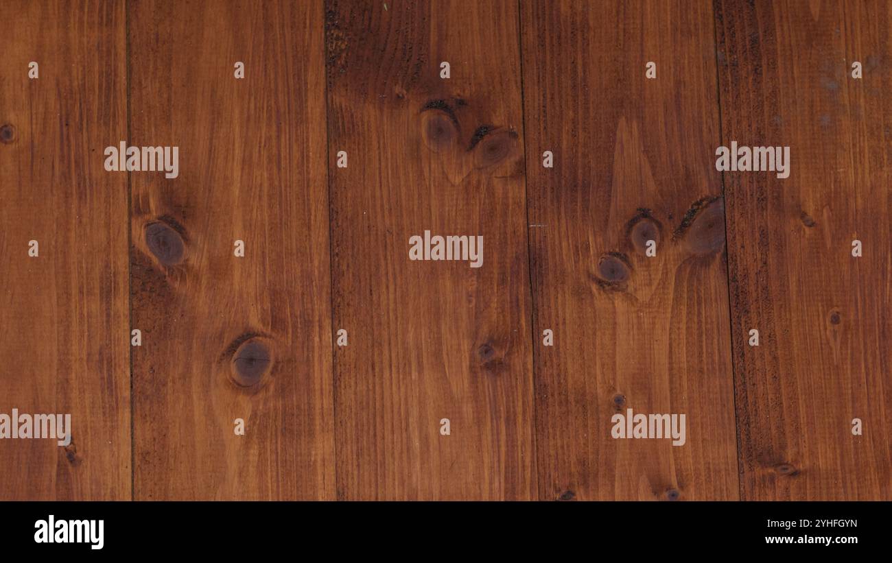 Close-up view of a dark wooden panel featuring unique knots and a rich ...