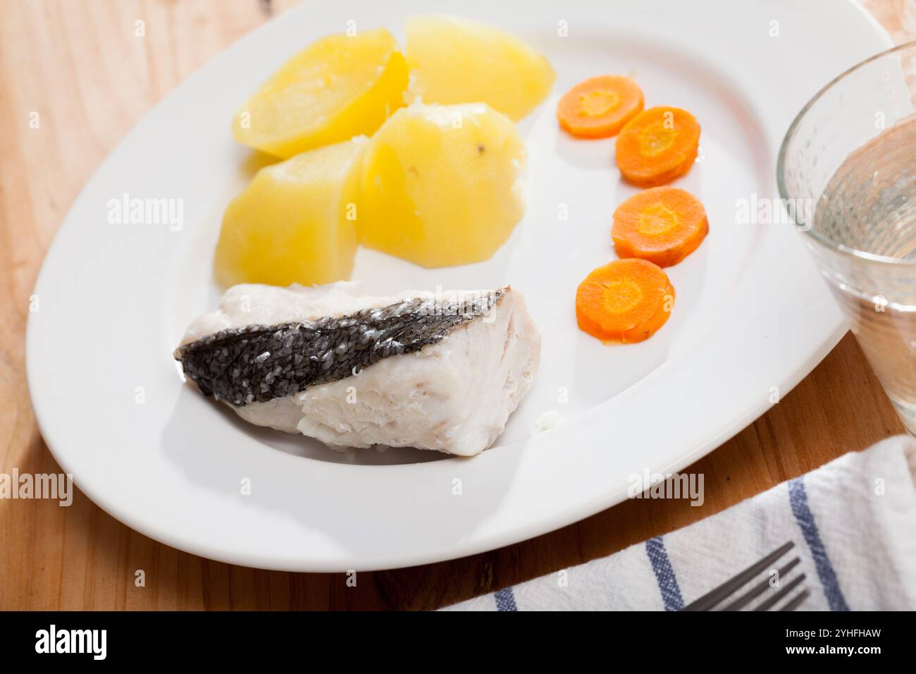 Steamed hake with potatoes and carrot Stock Photo - Alamy