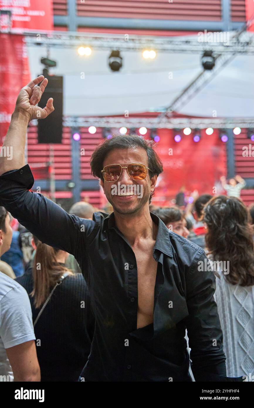 Indian man in black shirt and sunglasses celebrating at a concert ...