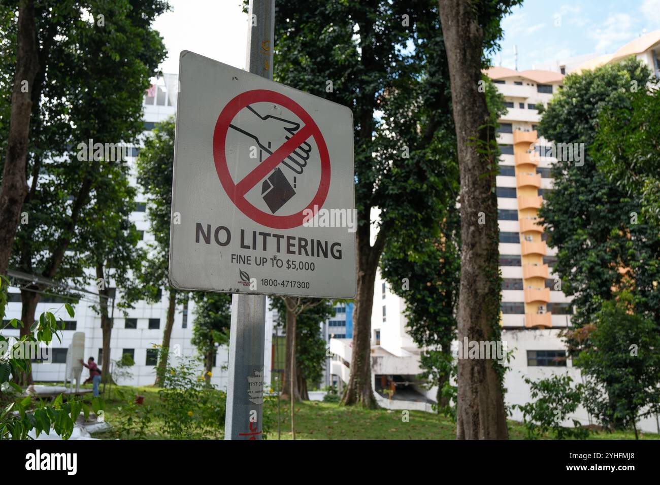 A warning sign in the street in Singapore warning about No littering ...