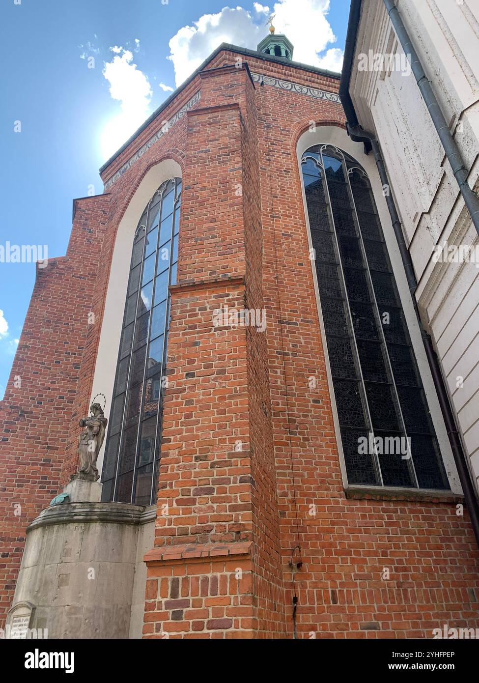 Historic Brick Church With Sunlit Windows and Sculpture Stock Photo - Alamy