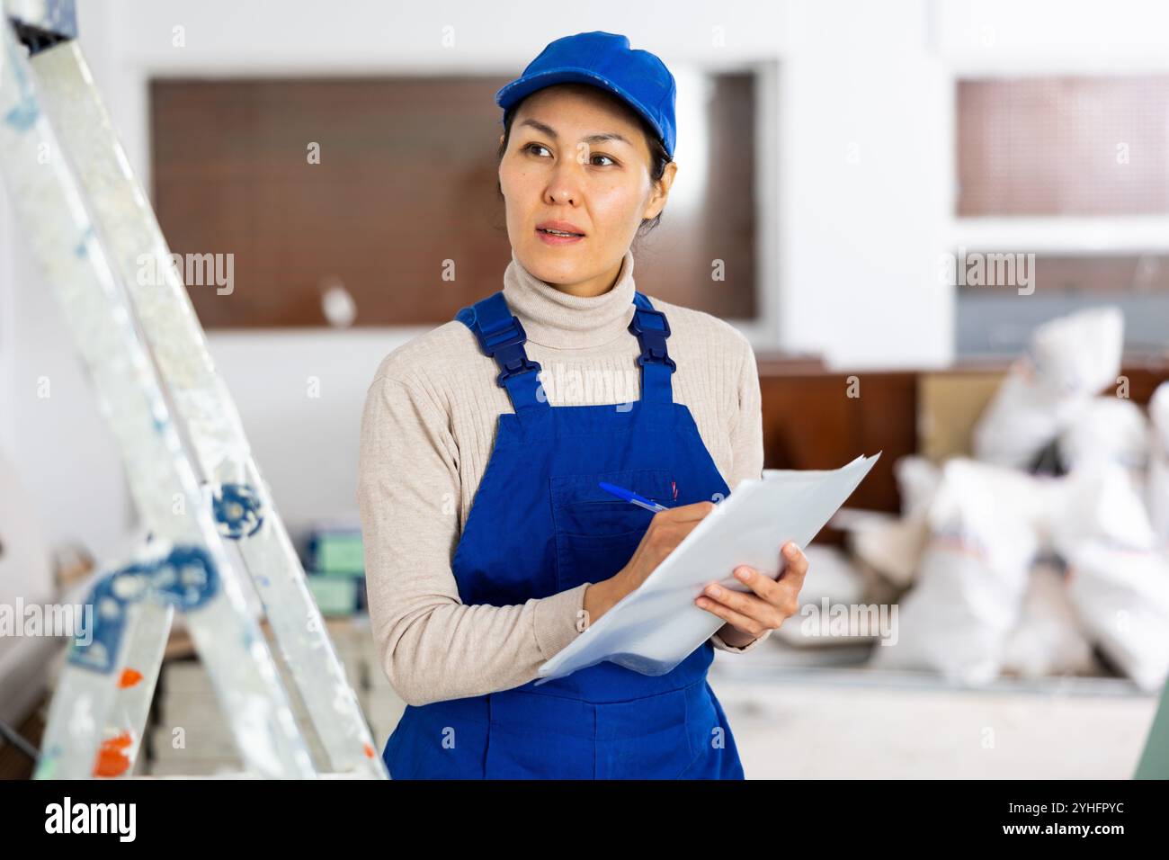 Female engineer matching check list during repair works Stock Photo - Alamy