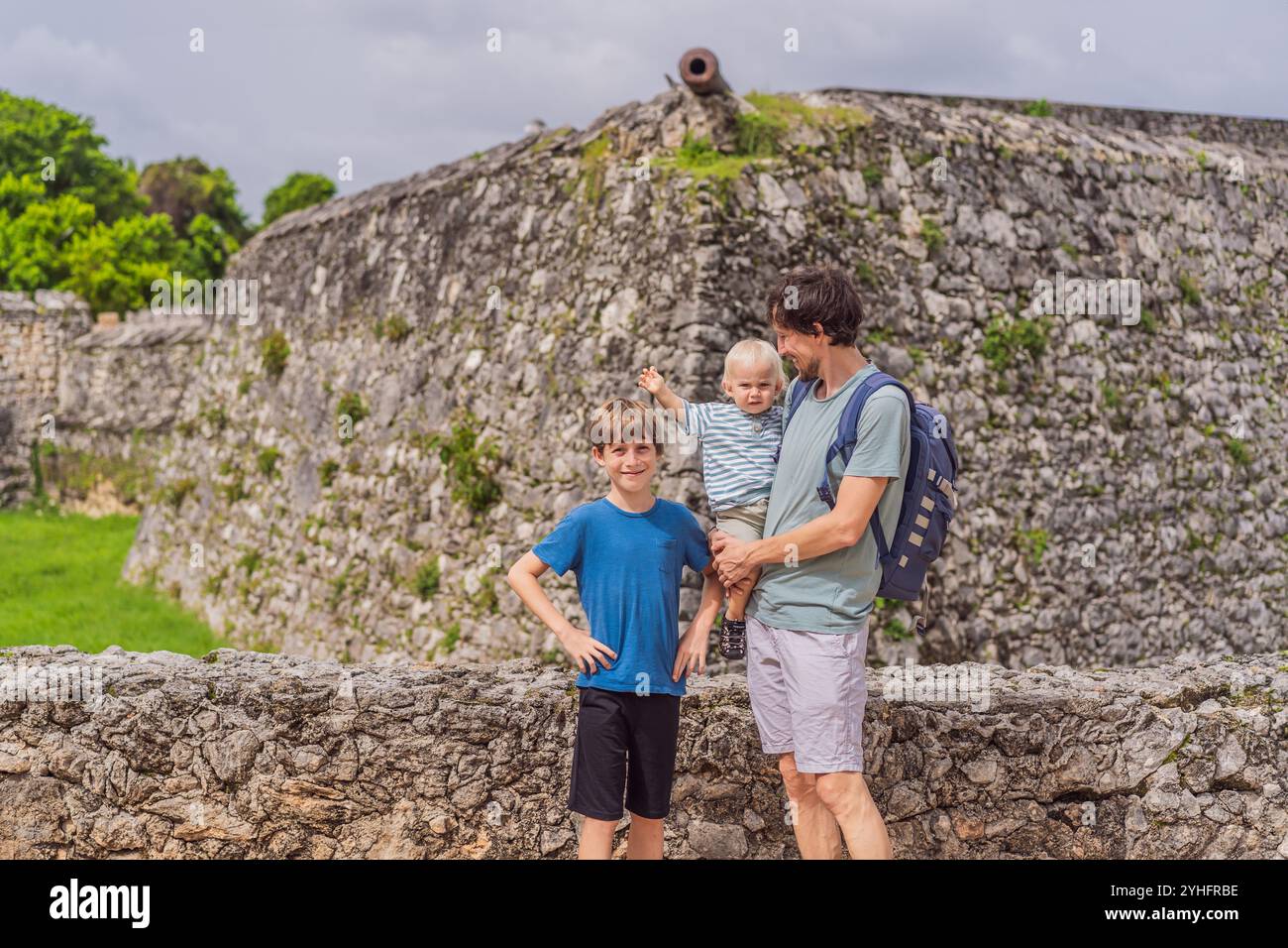 Father with his toddler and teenage sons exploring Fuerte de San Felipe ...