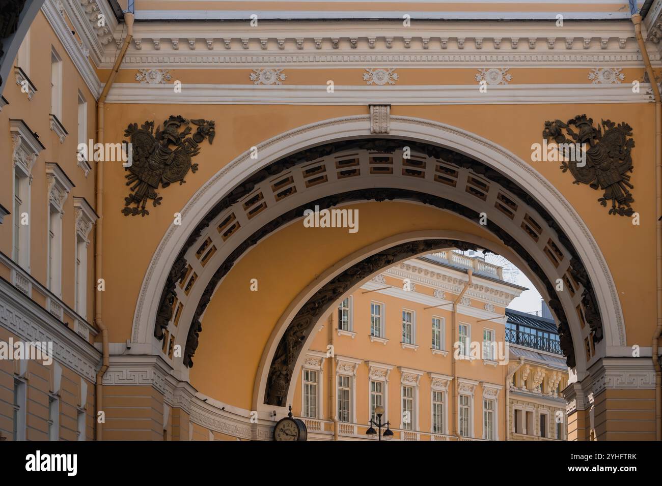 Ornate archway framing the view of historic buildings on a clear day ...