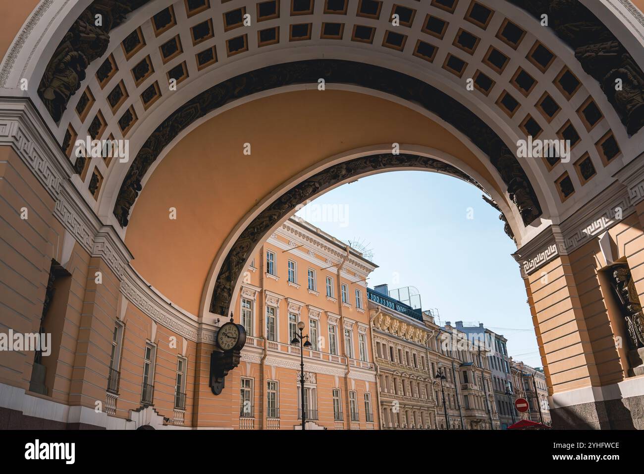 Ornate archway framing the view of historic buildings on a clear day ...