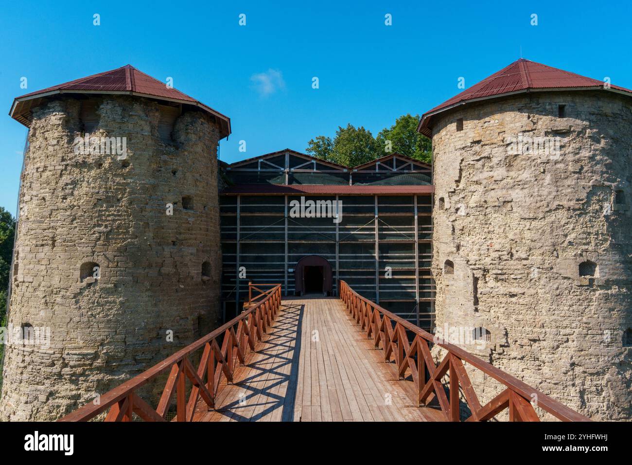 A grand entrance to an ancient fortress, featuring twin stone towers ...