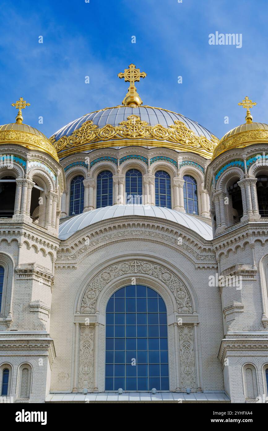 A grand cathedral with prominent golden domes and an ornate facade ...