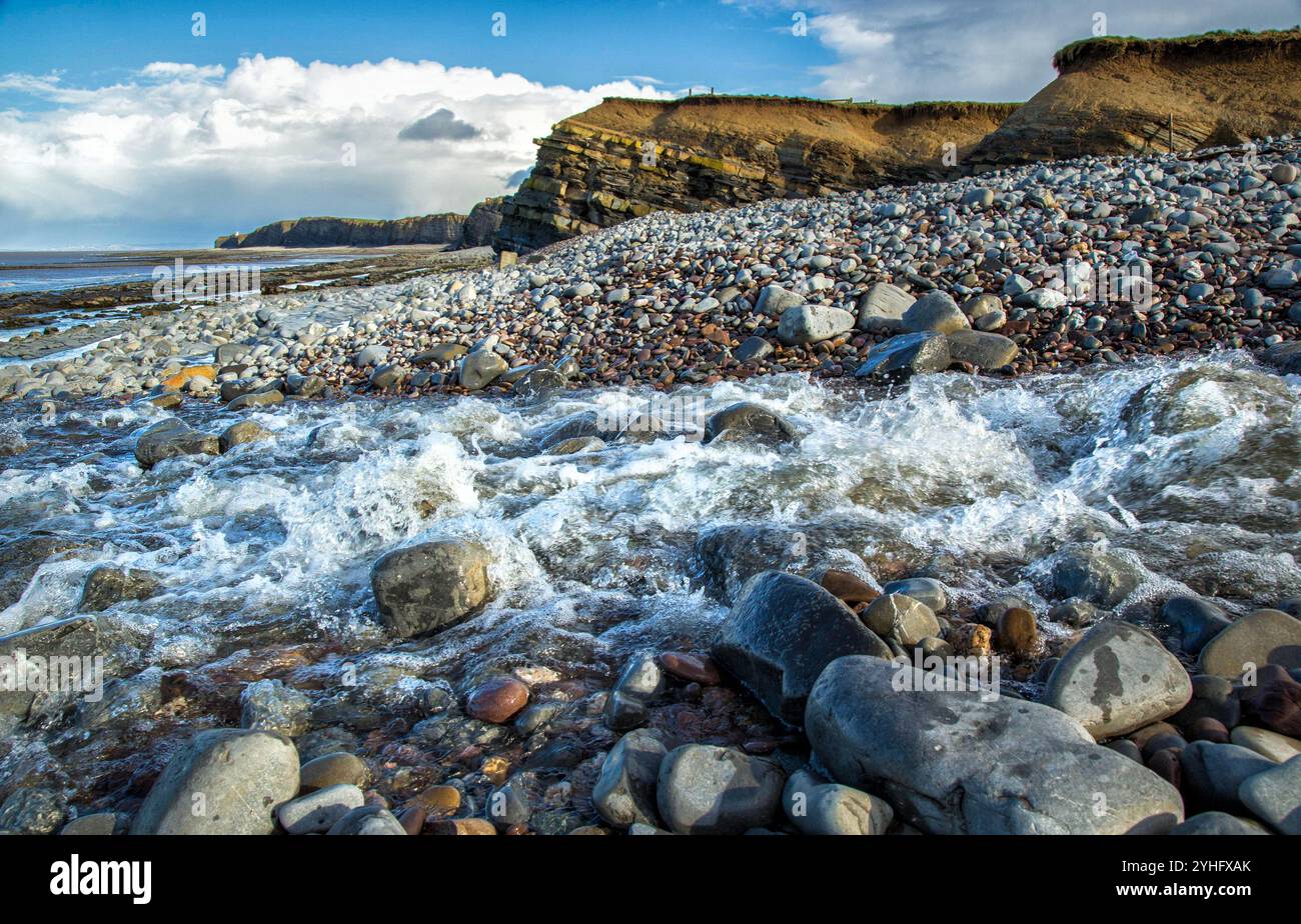 Kilve Pill river flowing down the rocky beach near East Quantoxhead on ...