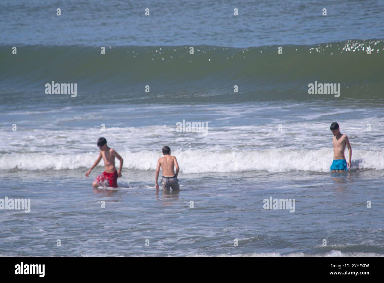 Young people taking a bath on the beach Stock Photo - Alamy