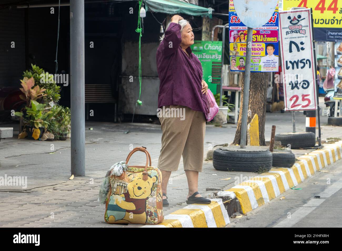 BANGKOK, THAILAND, MAR 09 2024, An elderly woman with luggage is ...