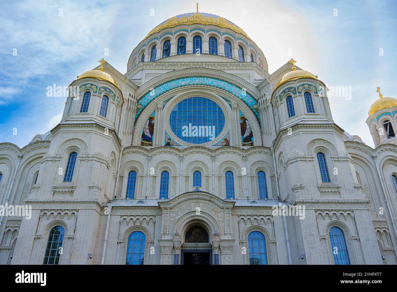 A grand cathedral with prominent golden domes and an ornate facade ...