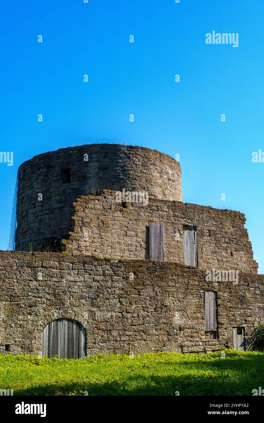 Ancient stone tower ruins standing against a clear blue sky ...