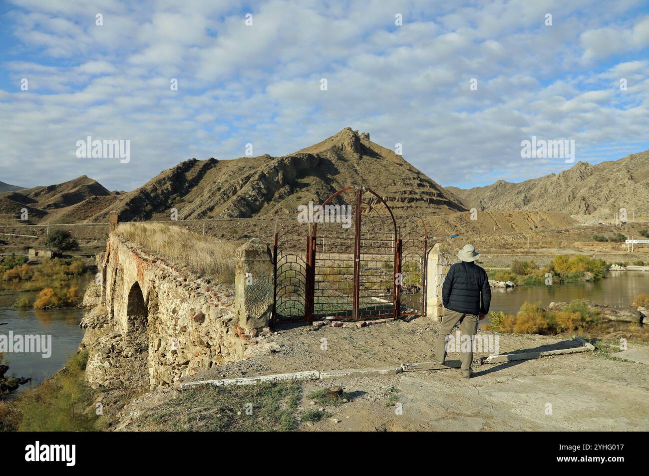 Traveller looking towards Iran from the gate of Khudafarin Bridge on ...
